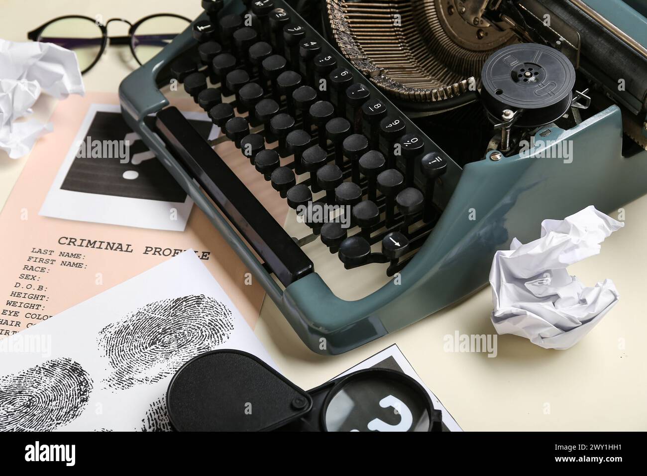 Retro typewriter, criminal files and crumpled paper balls on light ...