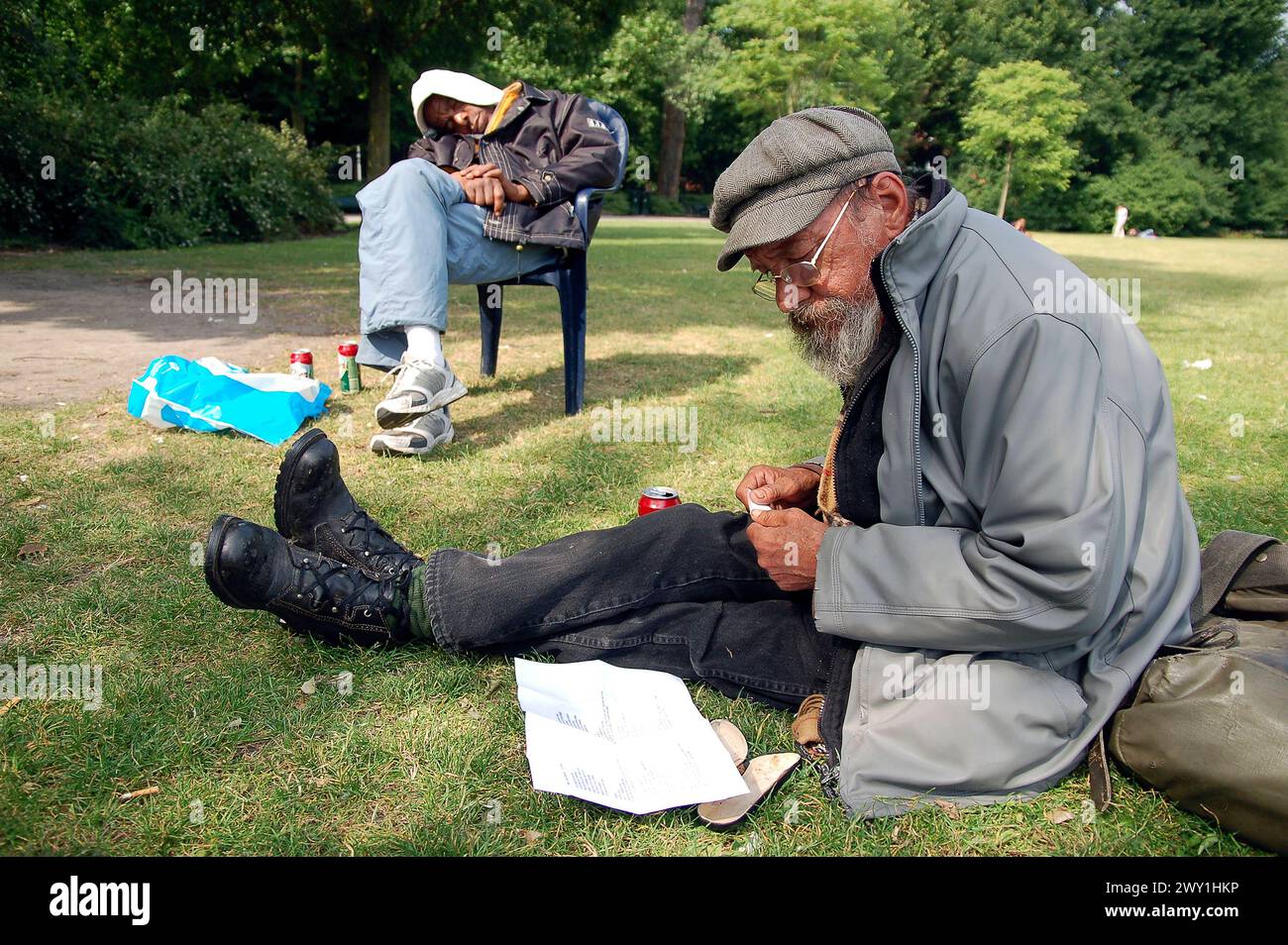 Homeless Alcohol User reading Paper Mature Adult, Homeless Alcohol User ...