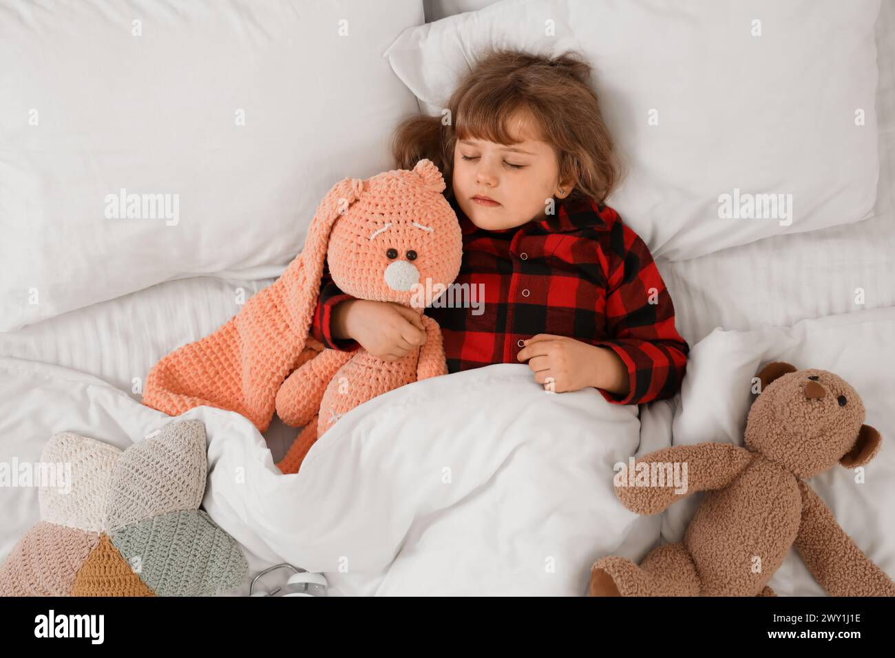 Adorable little girl with plush toys sleeping in bed Stock Photo - Alamy