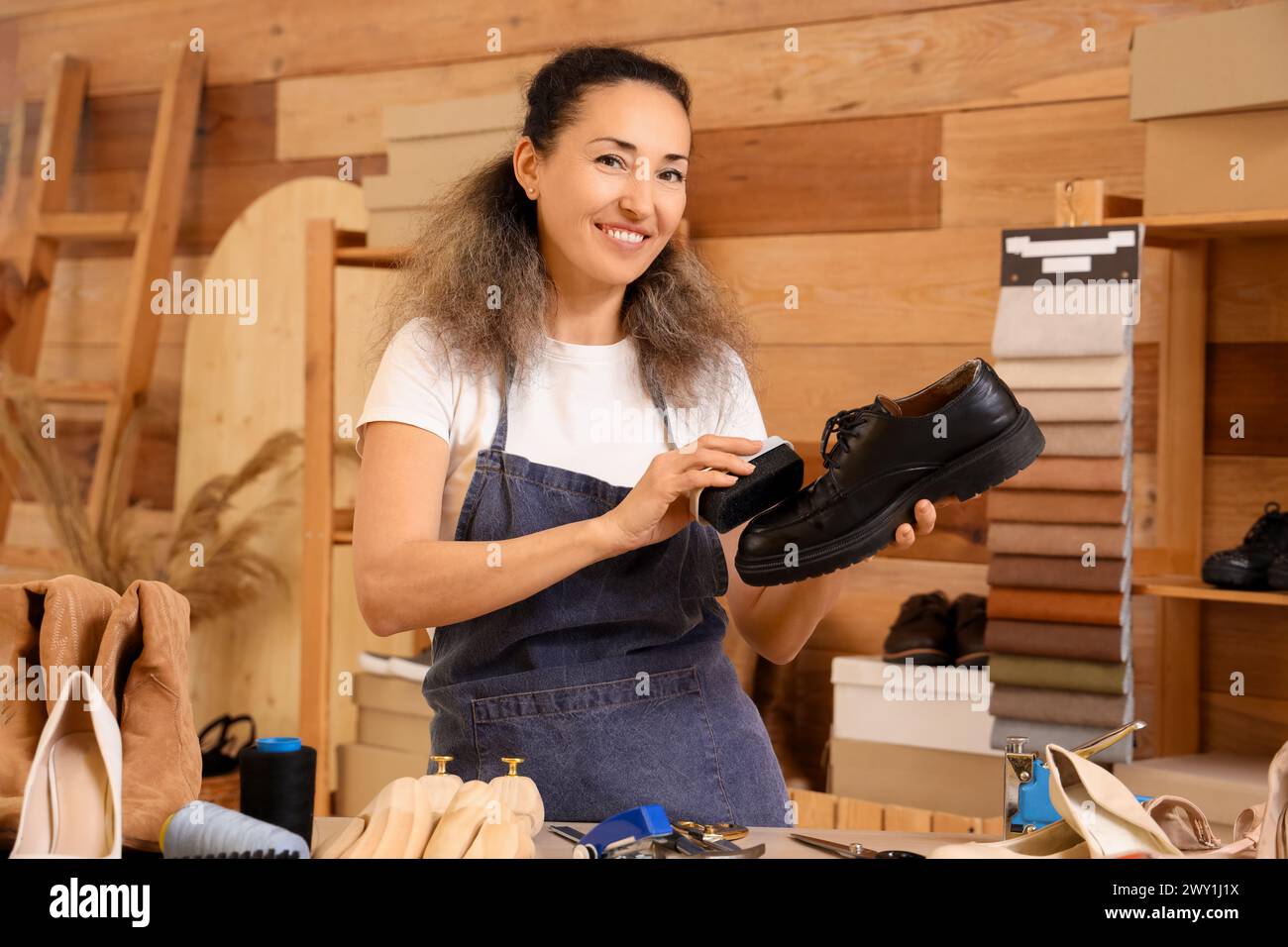 Female shoemaker polishing boot hi-res stock photography and images - Alamy