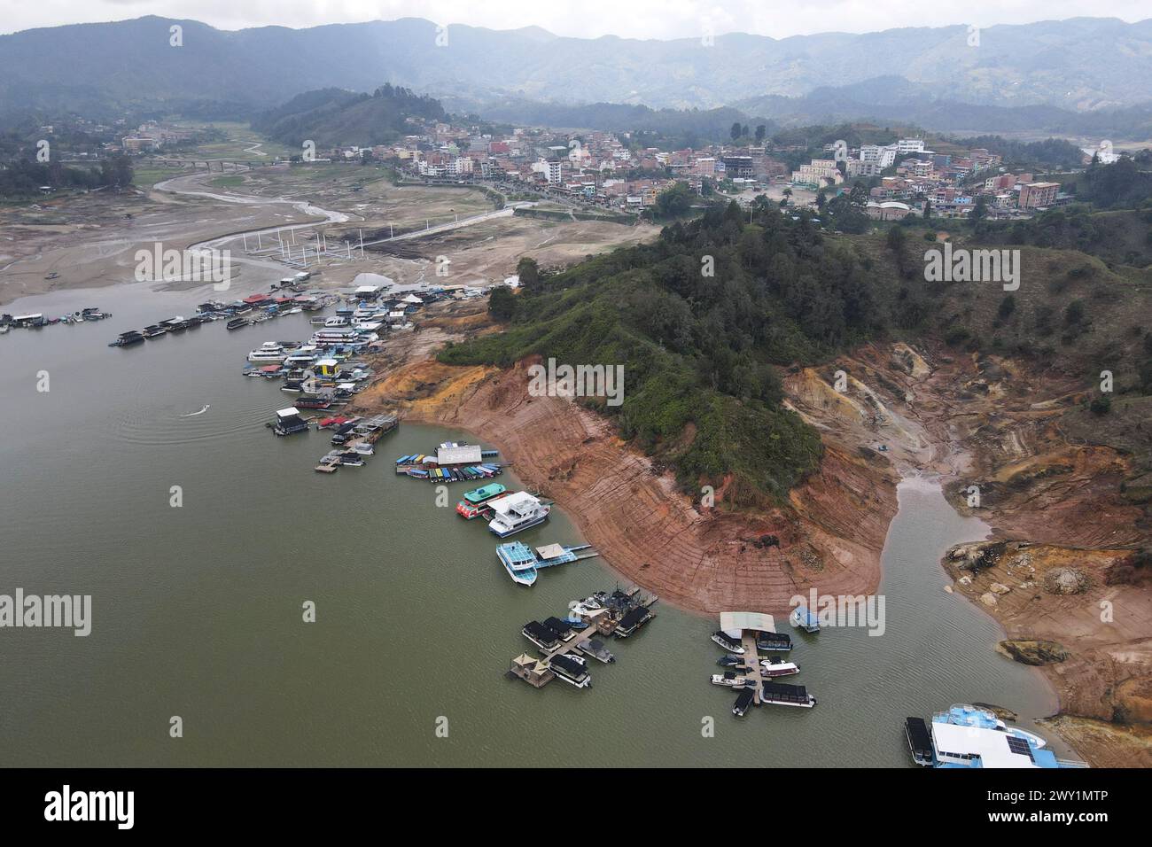 Boats are docked around the exposed banks due to low water levels of ...