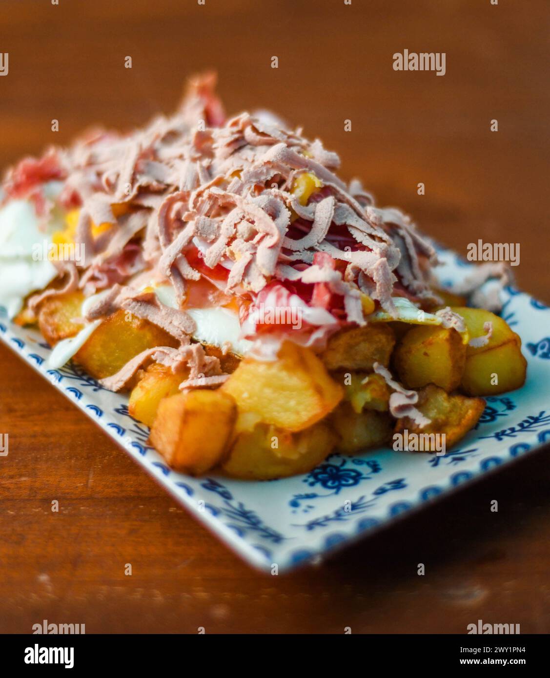 Portion of potatoes with fried eggs and cured Iberian ham Stock Photo ... Portion of potatoes with fried eggs and cured Iberian ham Stock Photo ...
