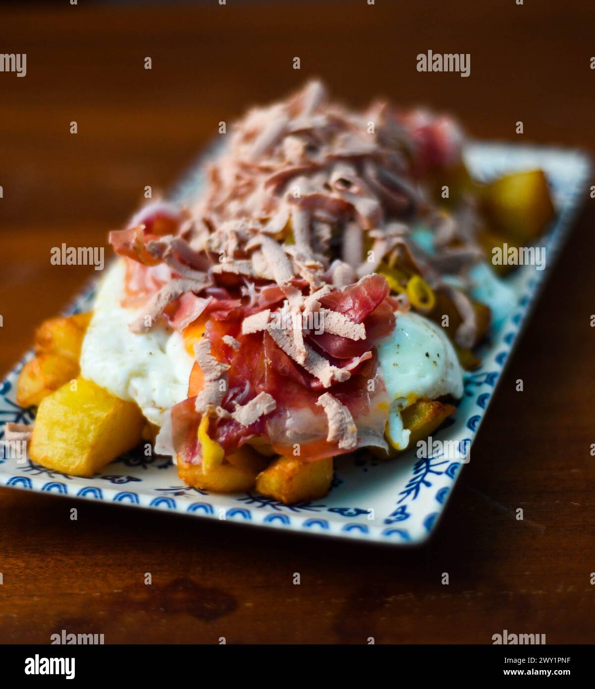 Portion of potatoes with fried eggs and cured Iberian ham Stock Photo ... Portion of potatoes with fried eggs and cured Iberian ham Stock Photo ...