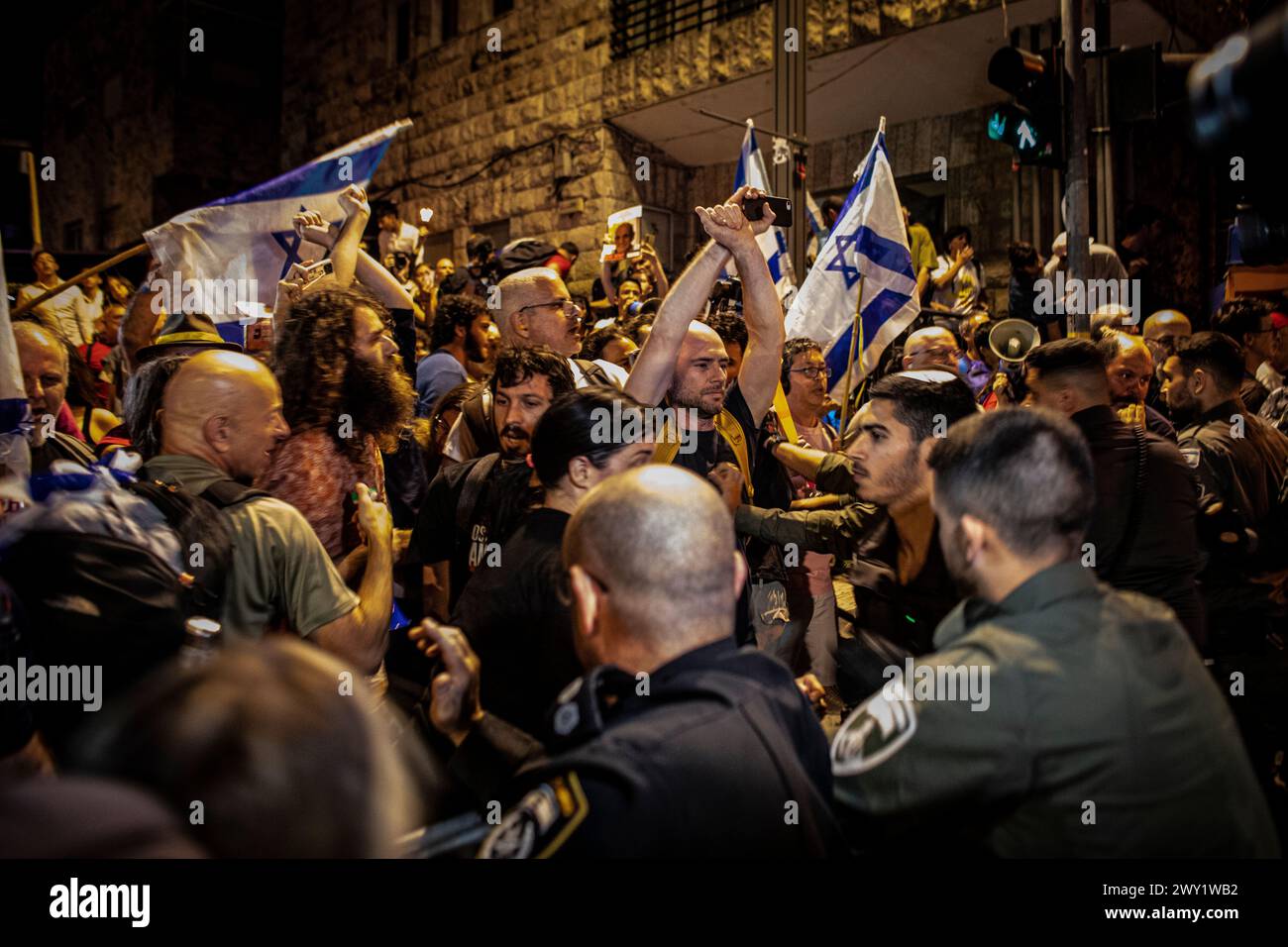 Israeli police officers push back a crowd of protestors during a ...