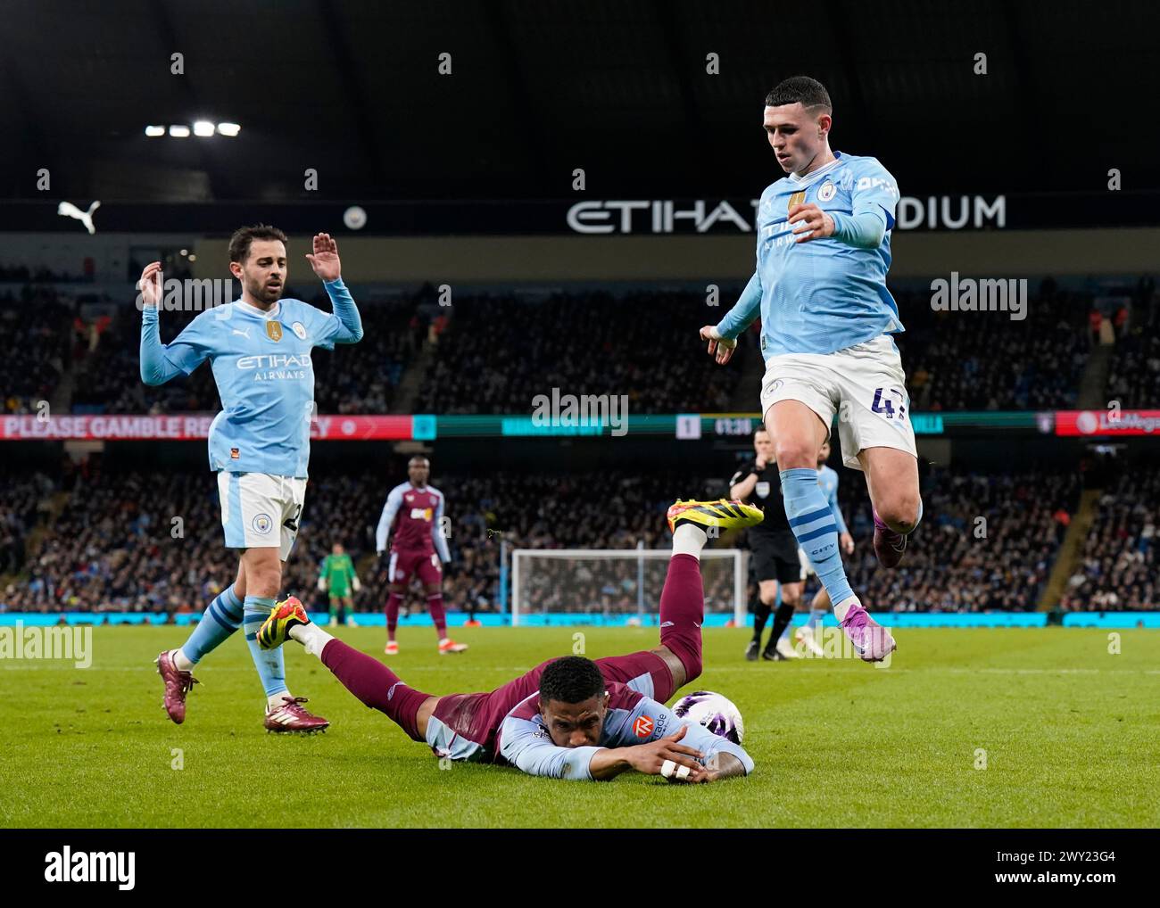 Manchester, UK. 3rd Apr, 2024. Ezri Konsa of Aston Villa tussles with ...