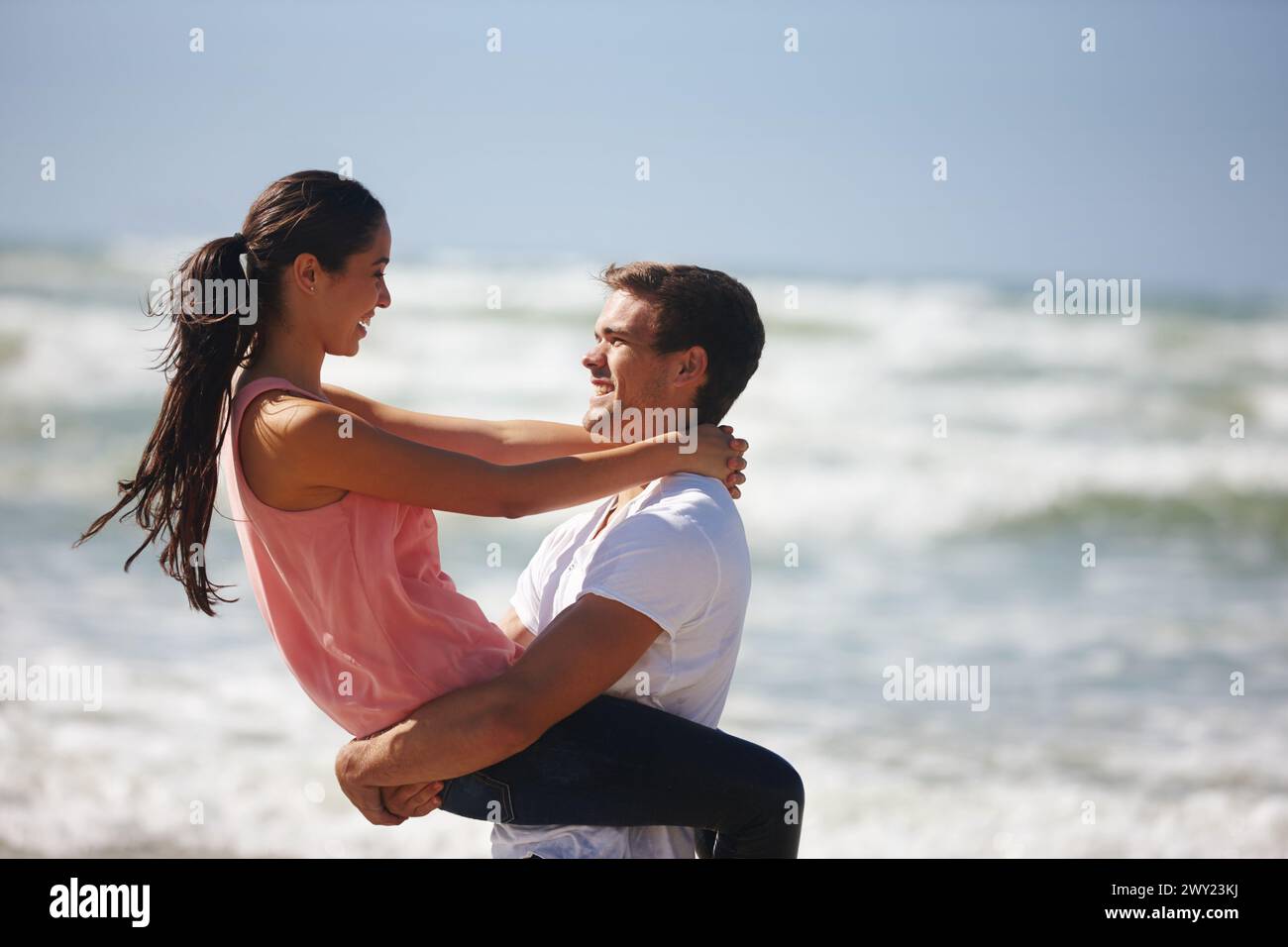 Ocean, couple and man lifting woman, travel and freedom at beach for ...