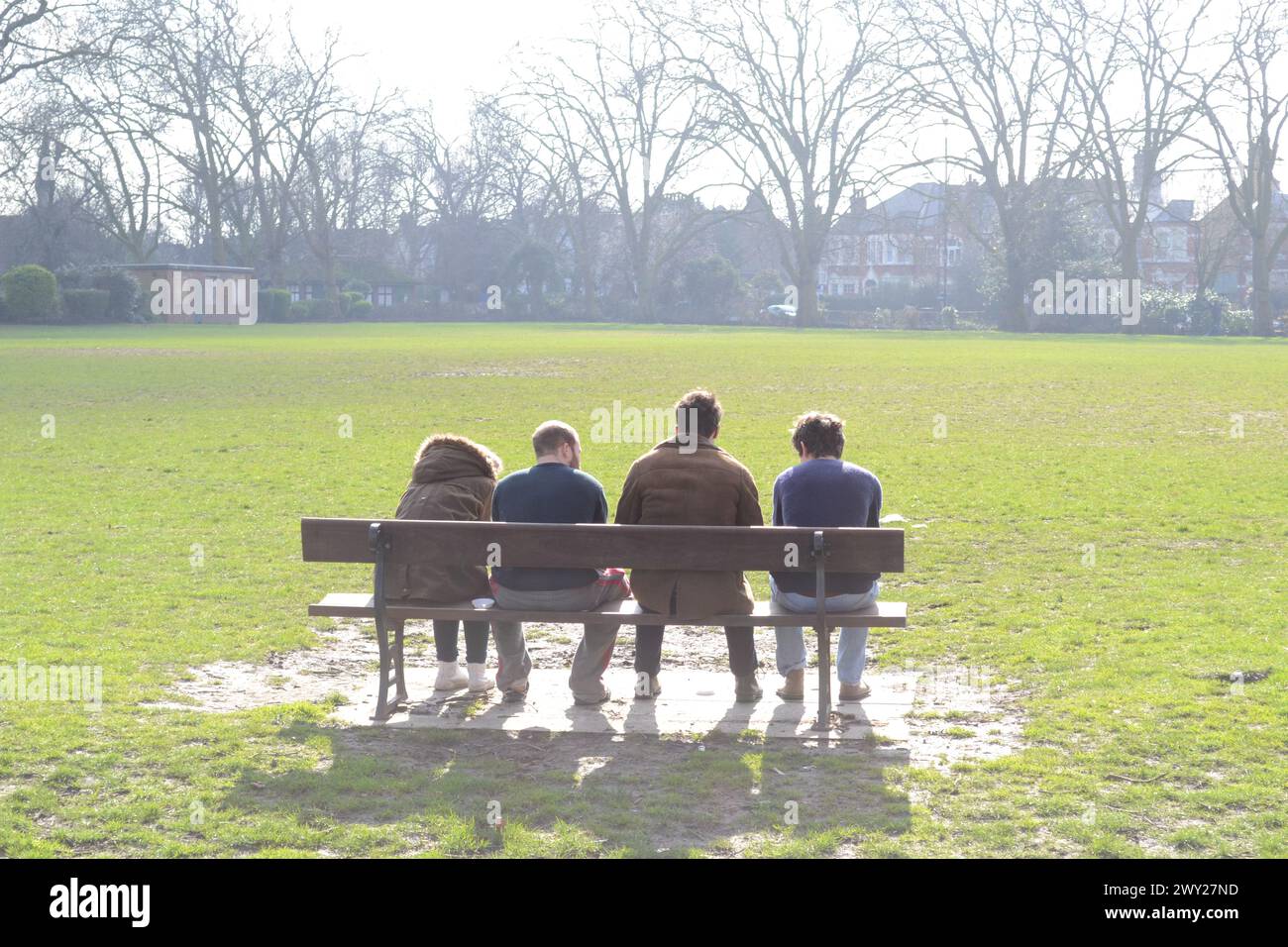 Friends on a park bench Stock Photo - Alamy