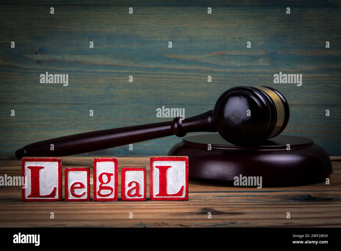 LEGAL. Red alphabet letters and judge's gavel on wooden background ...