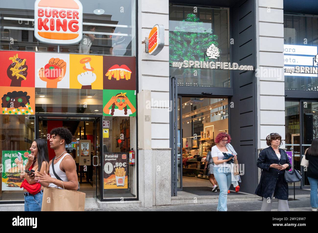 Pedestrians walk past the American chain of hamburger fast food ...