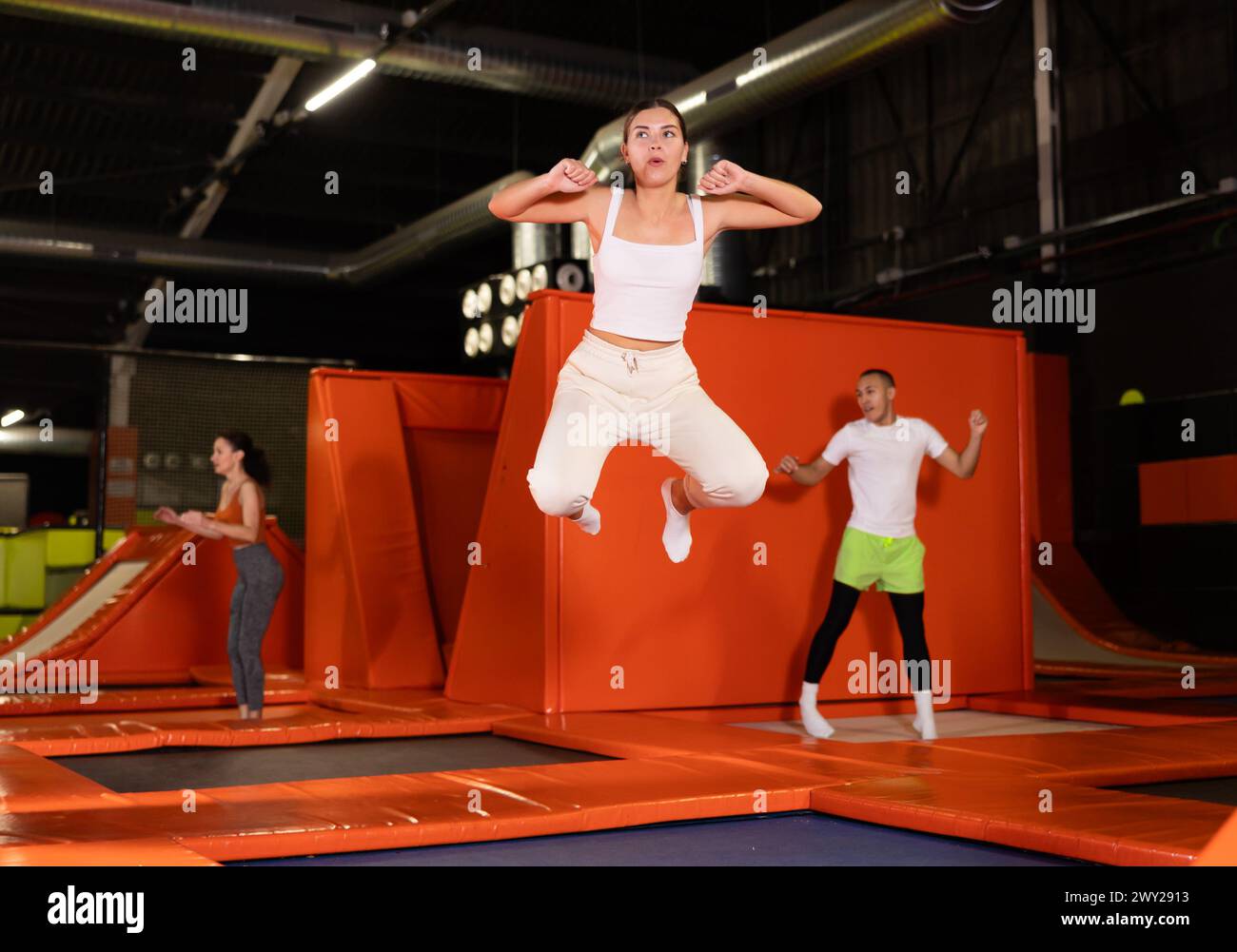 Excited young girl jumping at indoor trampoline center Stock Photo - Alamy