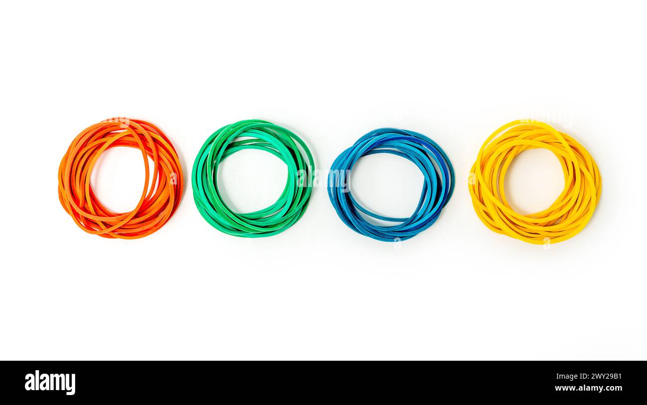 Stacks of different rubber bands on white background. Red, green, blue ...