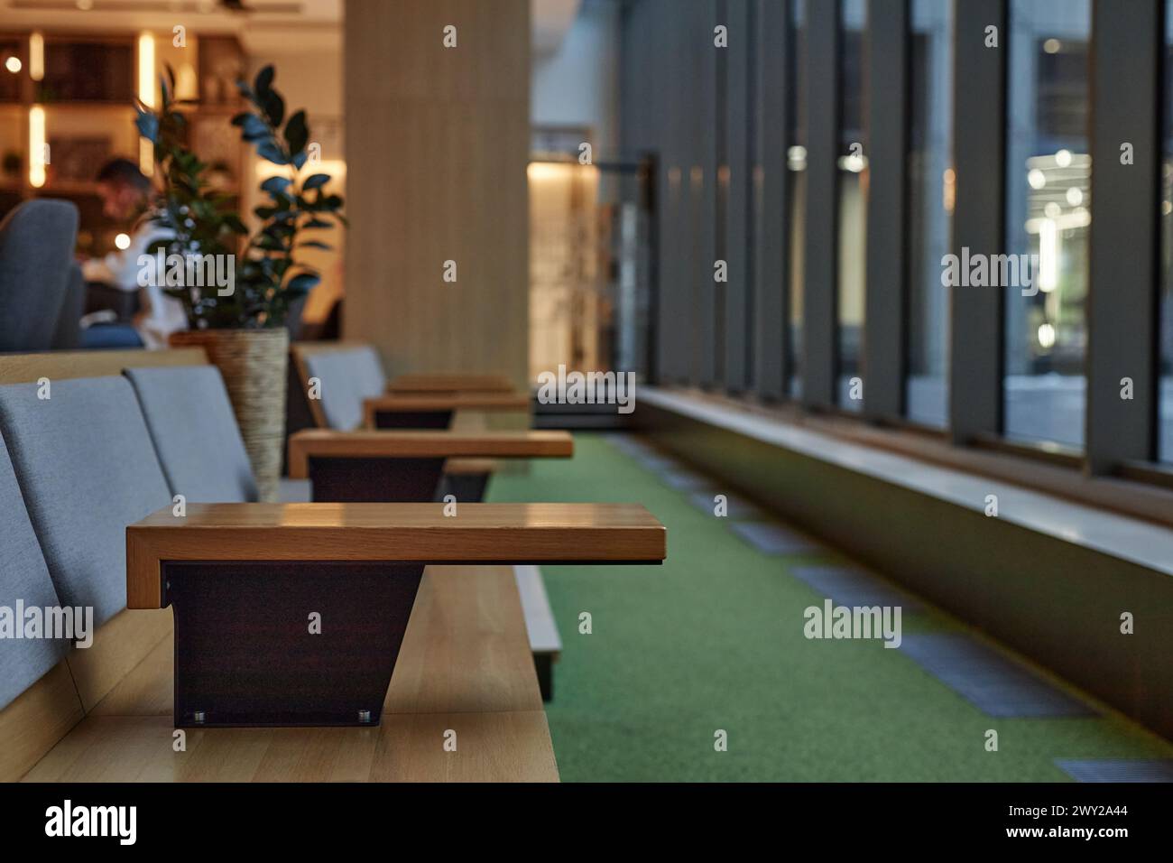 Minimal geometric image of seating row facing windows in hotel lobby or ...