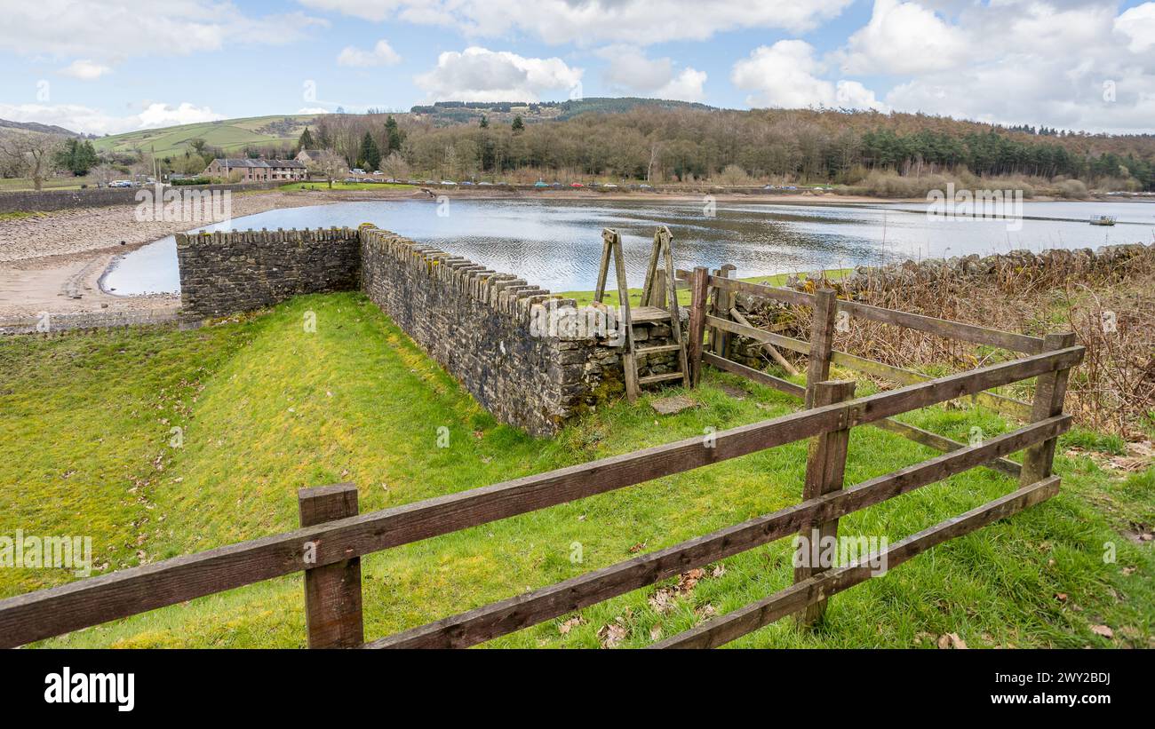 A wooden style seen over a stone wall pictured surrounding part of ...
