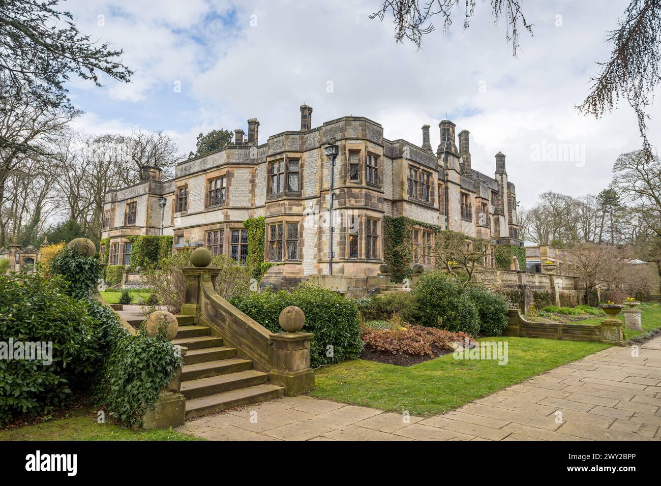 An HDR image of Thornbridge Hall framed by trees in its formal garden ...