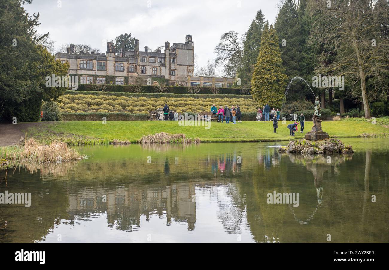 Thornbridge Hall pictured behind the pond, visitors and gardens seen in ...