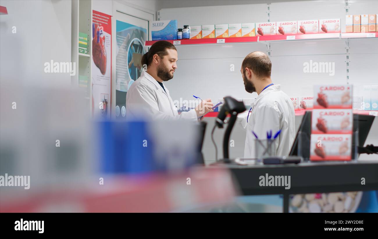 Team of employees providing full stock of medical goods in a pharmacy ...