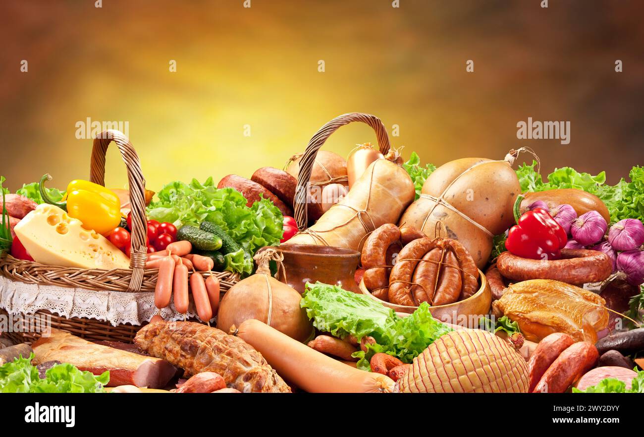 Varied assortment of prepared meats and sausages with vegetables and ...