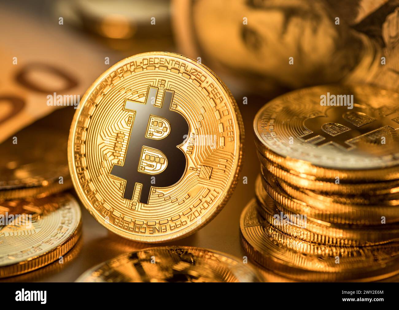 Gold bitcoin coins on a gold background. Symbol of electronic currency ...