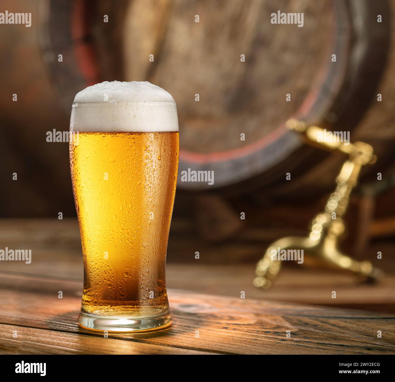 Glass of chilled beer and wooden beer cask on the background Stock ...