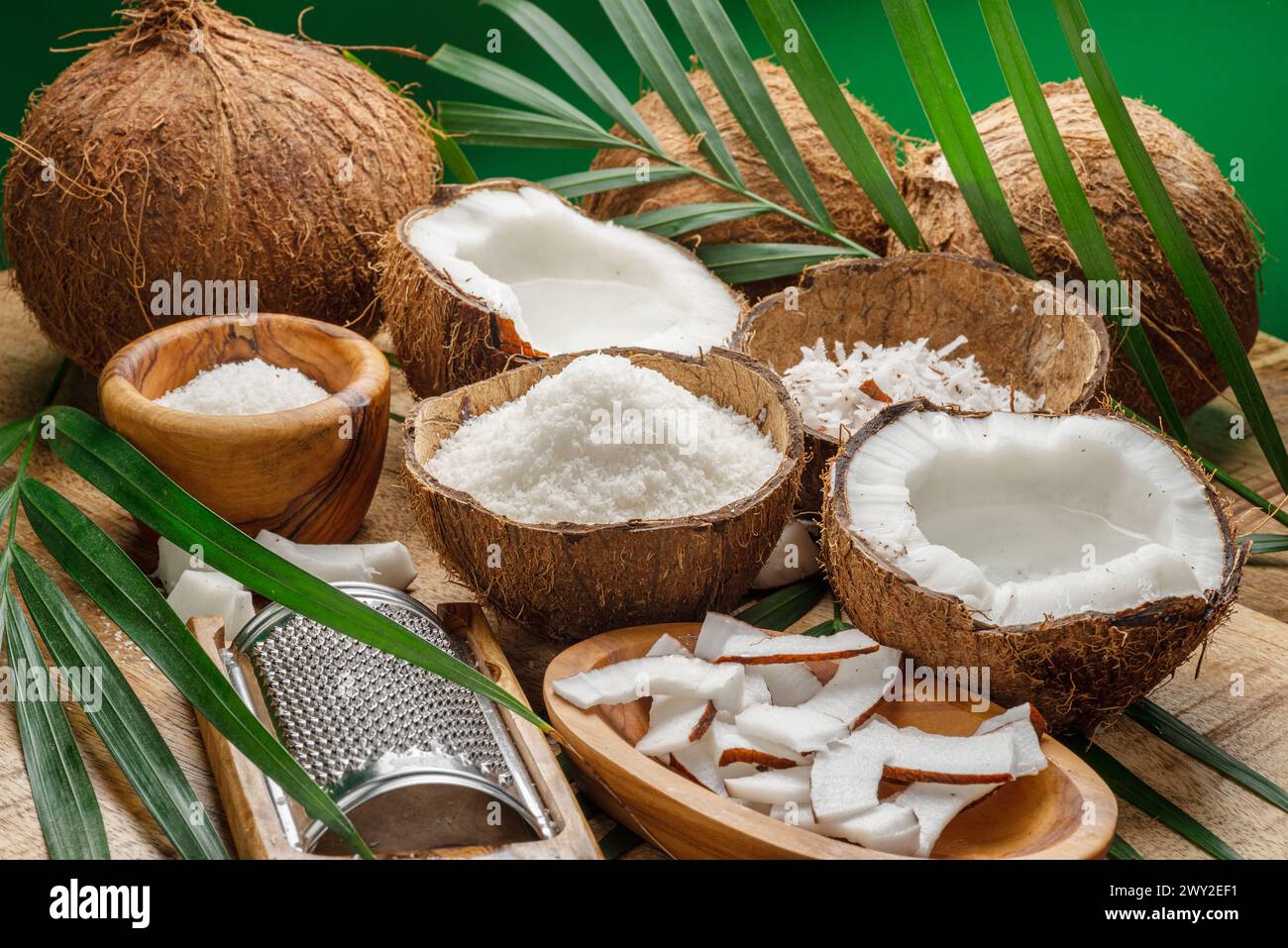 Fresh opened coconuts along with coconut slices, flakes and coconut ...