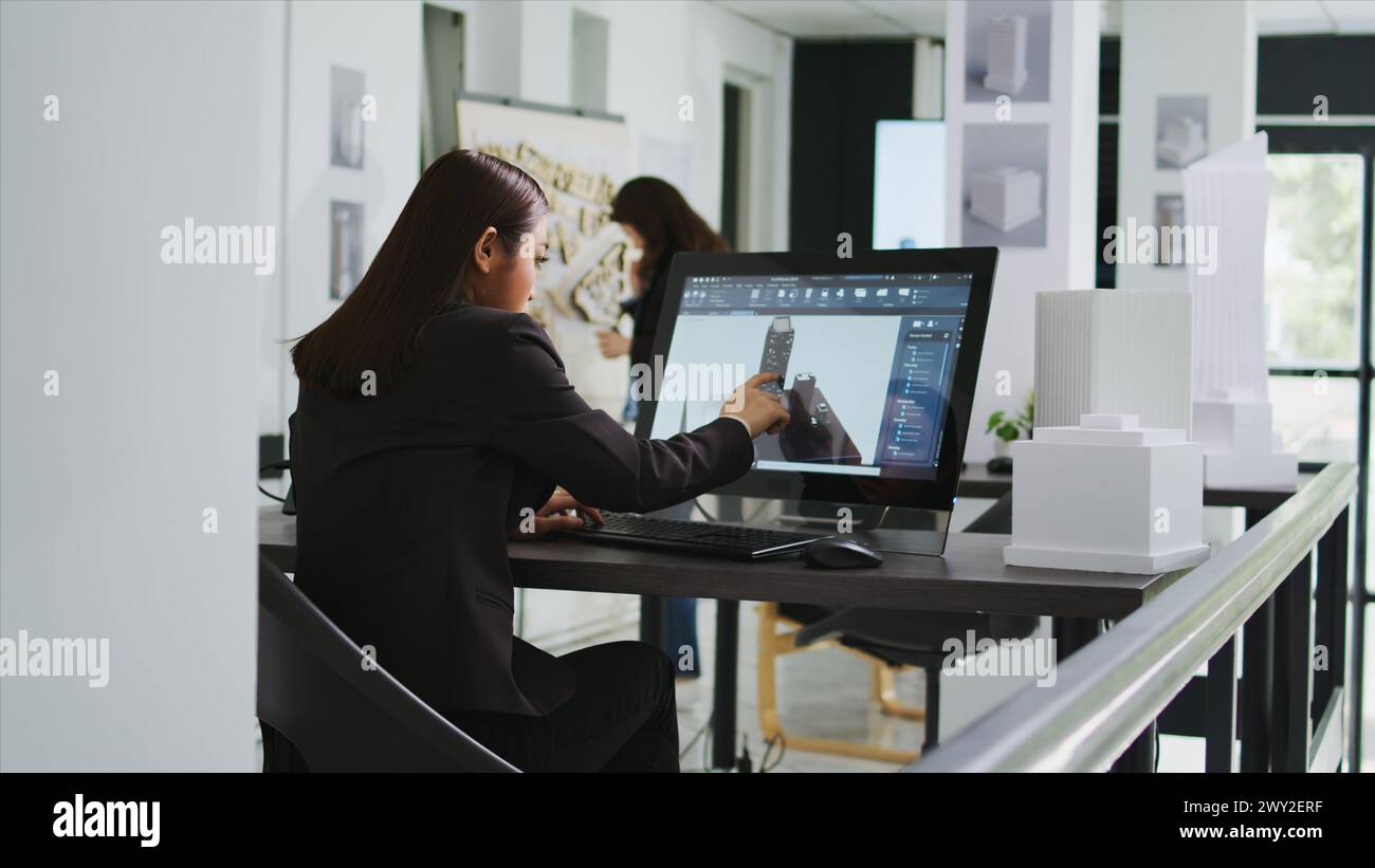 Architect reviewing residential area building plans on pc, working with ...