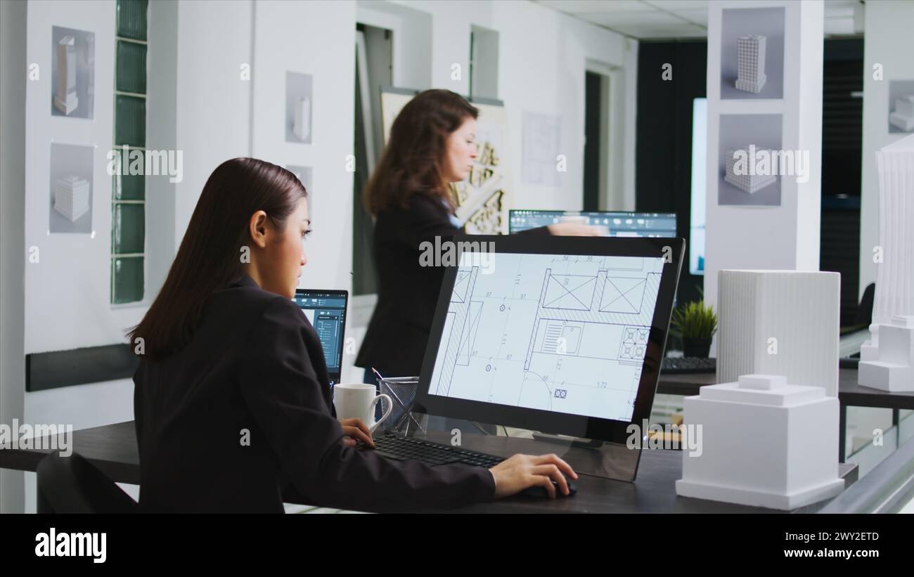 Asian graphic artist designing floor plan blueprint using modern ...