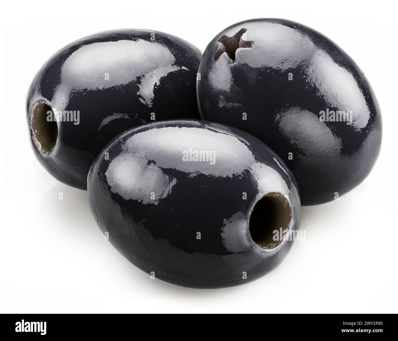 Three pitted black olives isolated on white background Stock Photo - Alamy