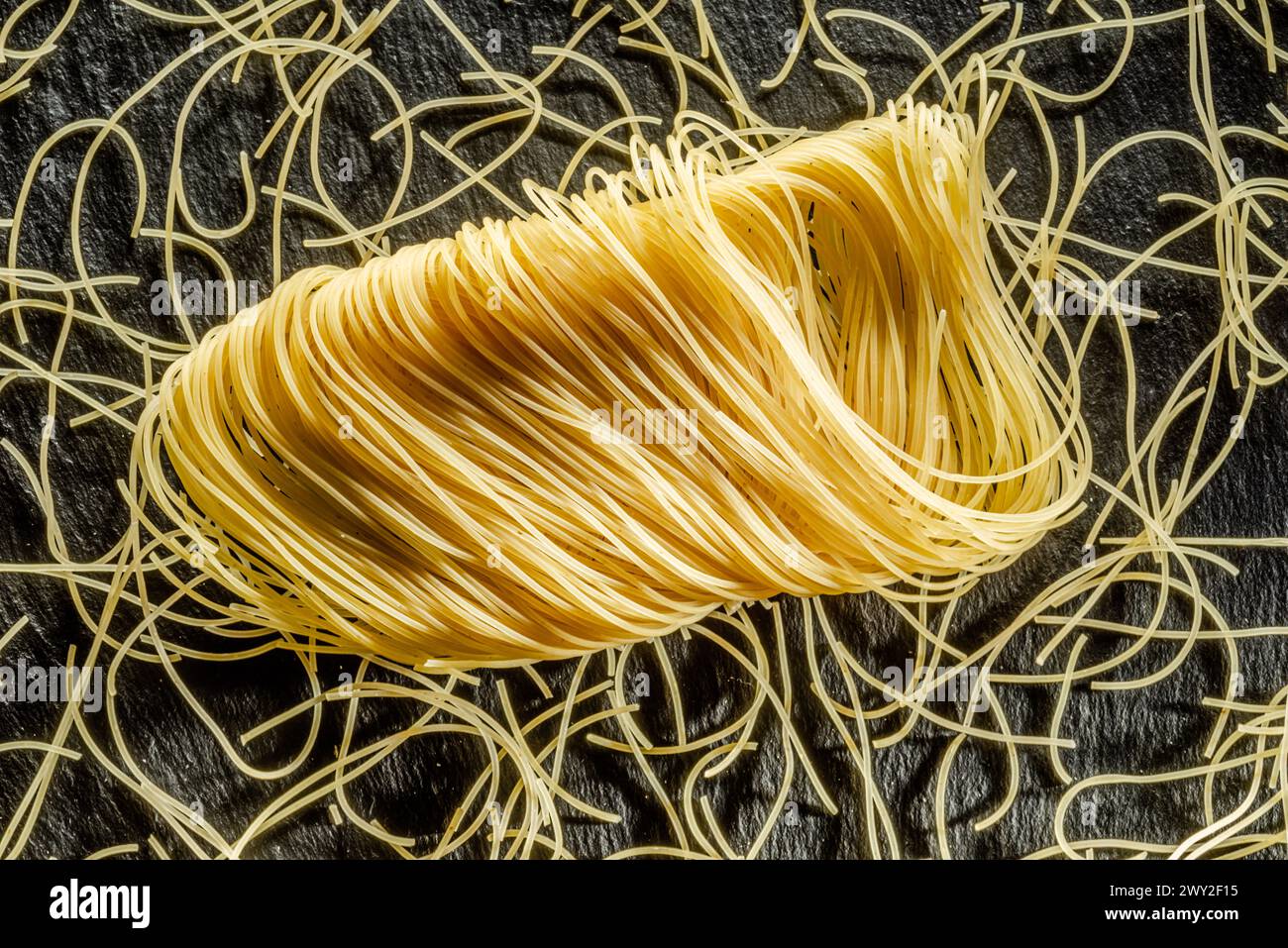 Italian pasta vermicelli close-up on black background. Food background ...