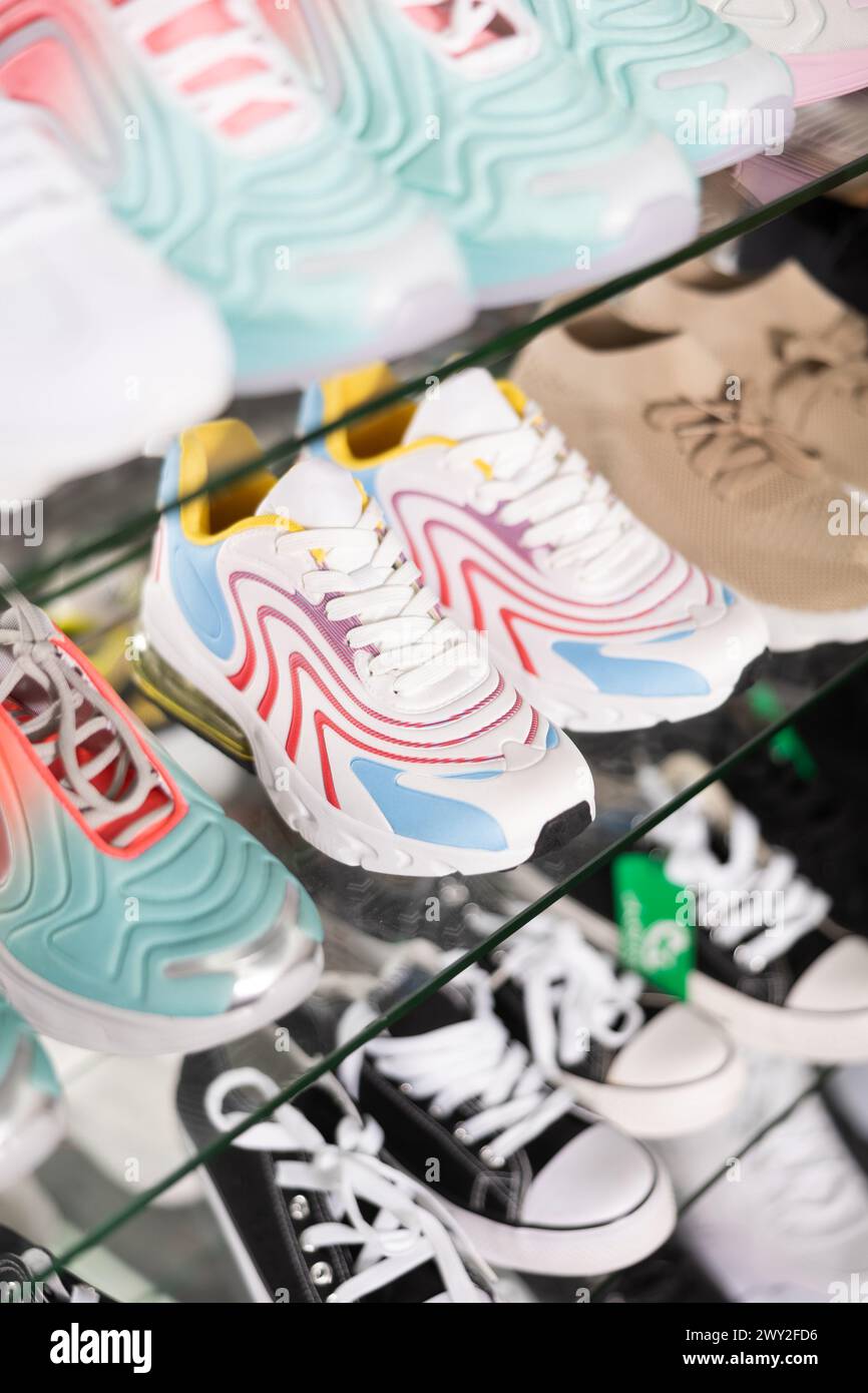 Showcase with models of sneakers in shoe store Stock Photo - Alamy