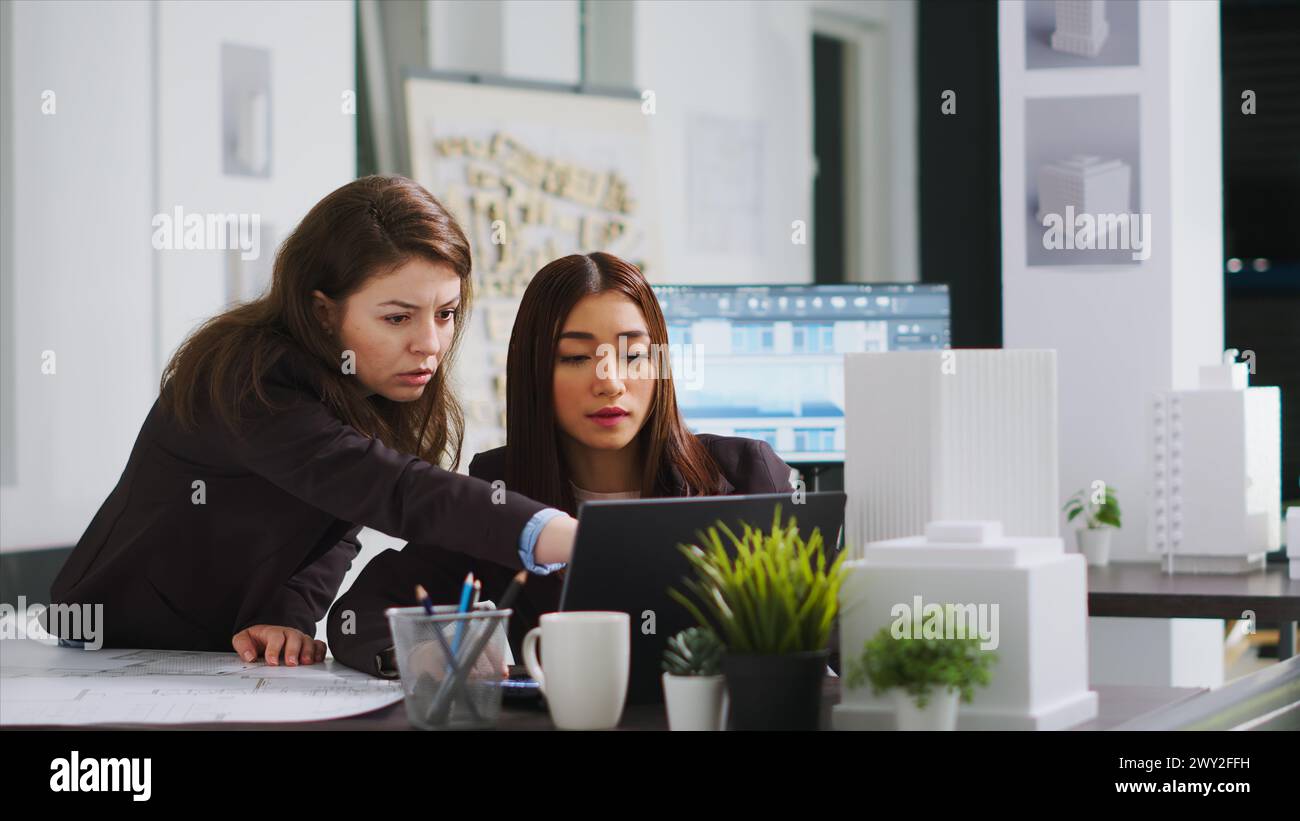 Industrial engineers designing floor plan sketch on cad software, using ...