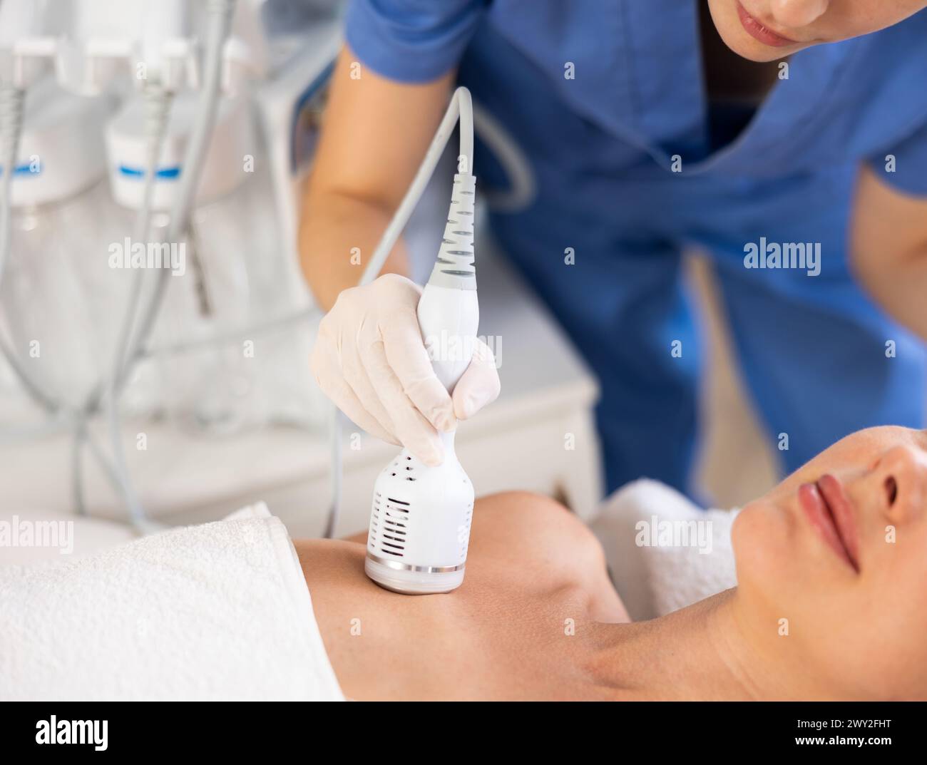 Female patient receiving hardware procedure on chest and neck area ...