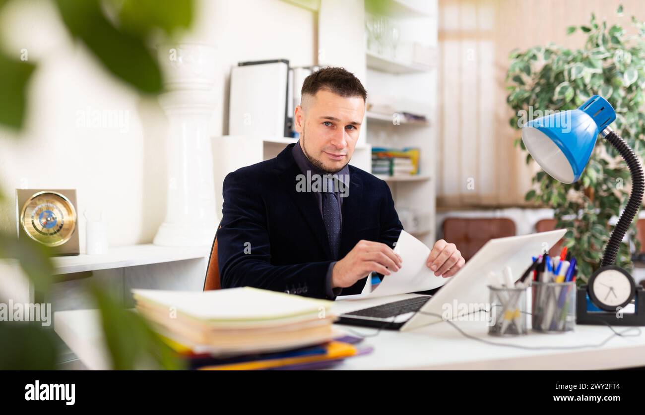 Man office worker doing his paperwork Stock Photo - Alamy