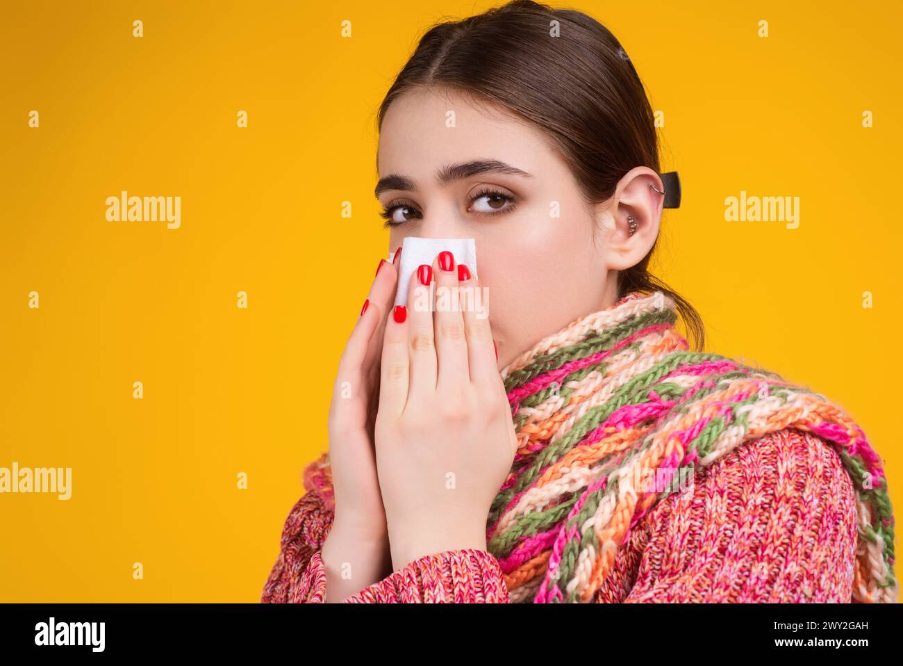 Blow the snot. Woman in sweater and scarf hold napkin blow snot ...