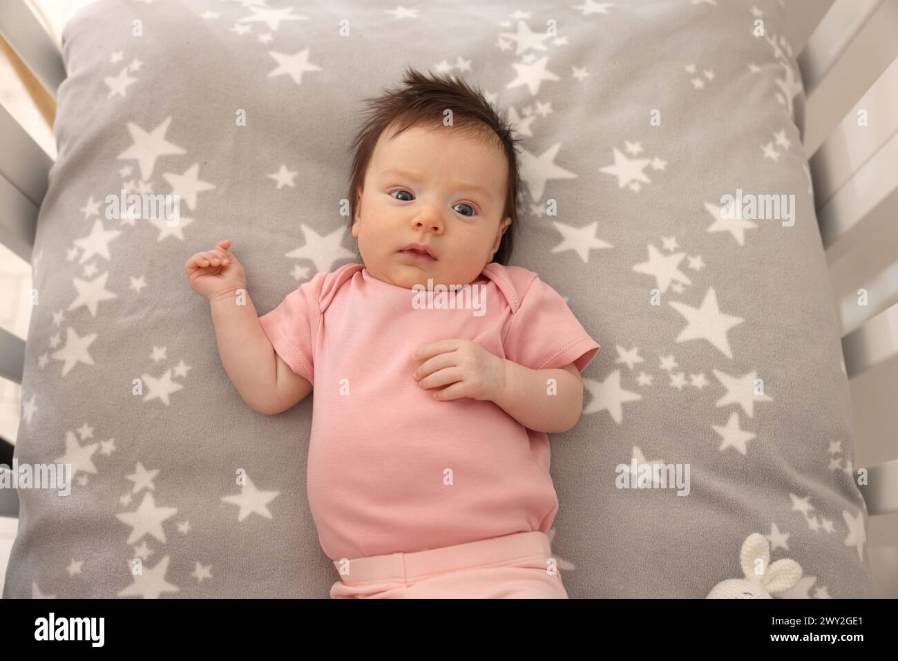 Getting ready for bed. Cute little baby lying in crib, top view Stock ...