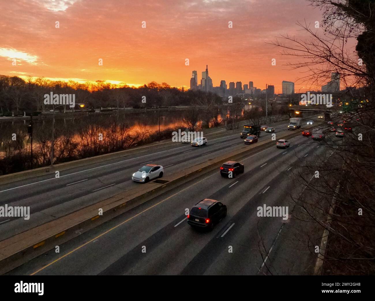 The sun rises over the Philadelphia skyline and traffic on the ...