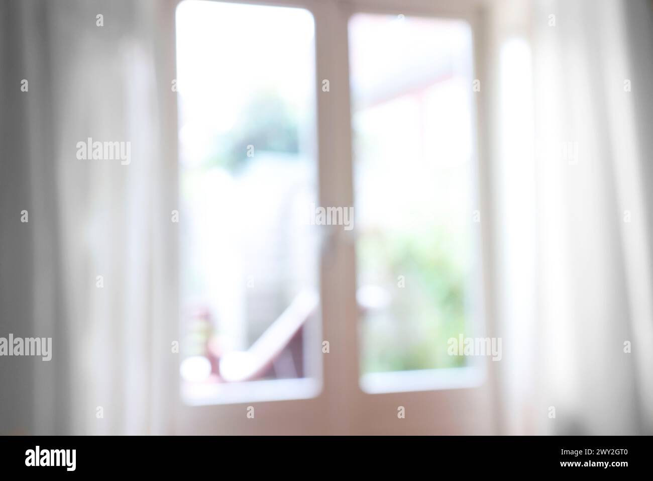 Blurred view of glass door at home Stock Photo - Alamy