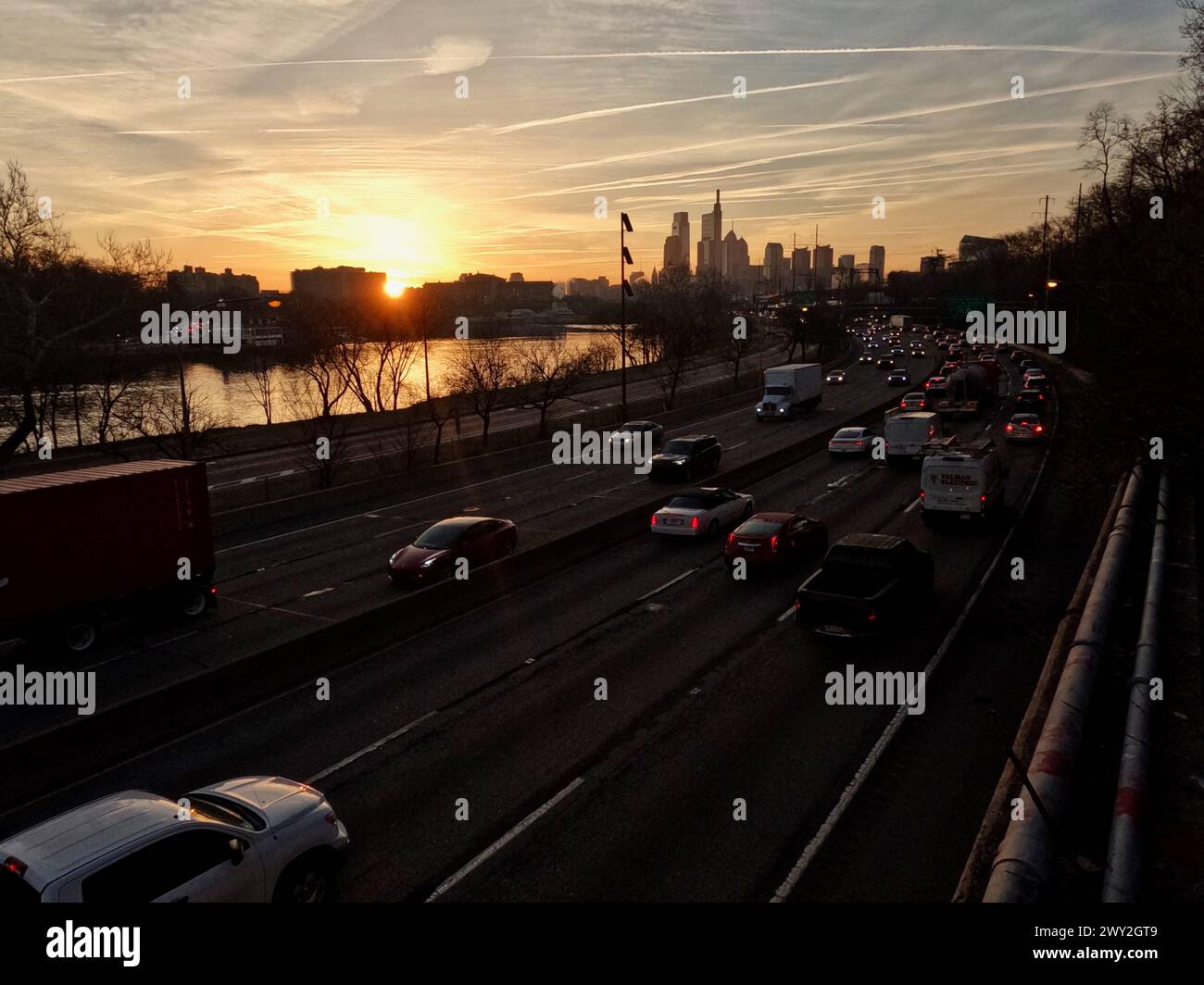 The sun rises over the Philadelphia skyline and traffic on the ...