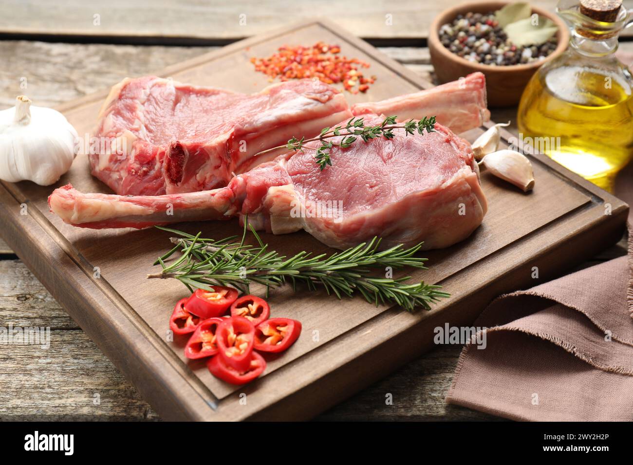 Fresh tomahawk beef cuts and spices on wooden table Stock Photo - Alamy
