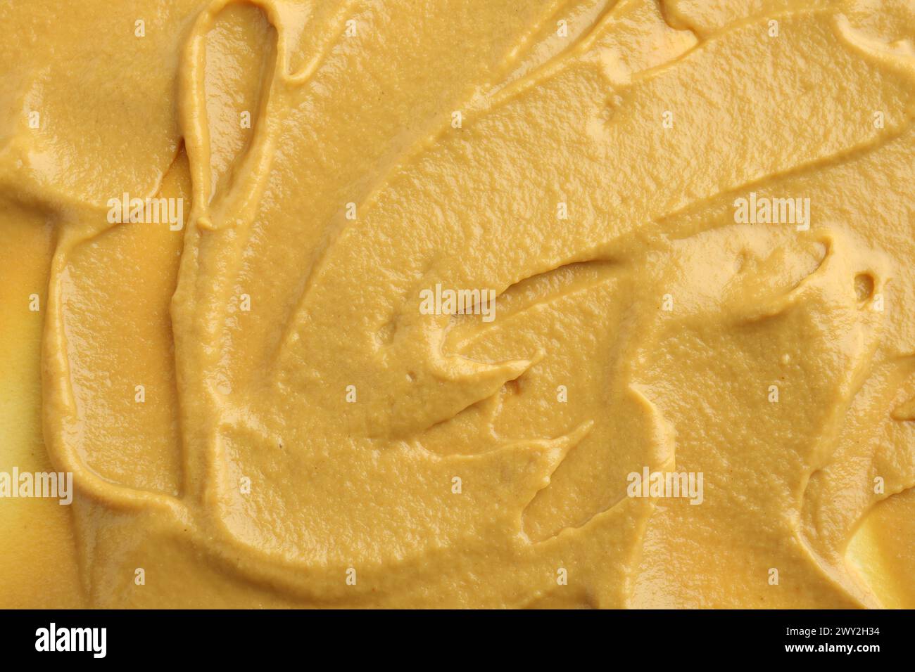 Fresh tasty mustard sauce as background, top view Stock Photo - Alamy