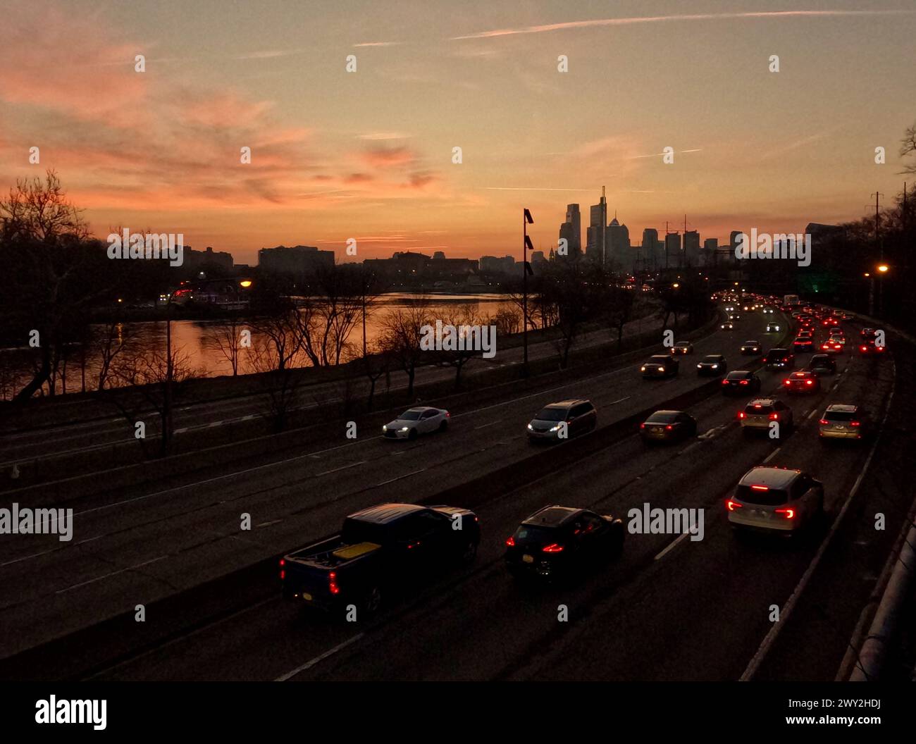The sun rises over the Philadelphia skyline and traffic on the ...