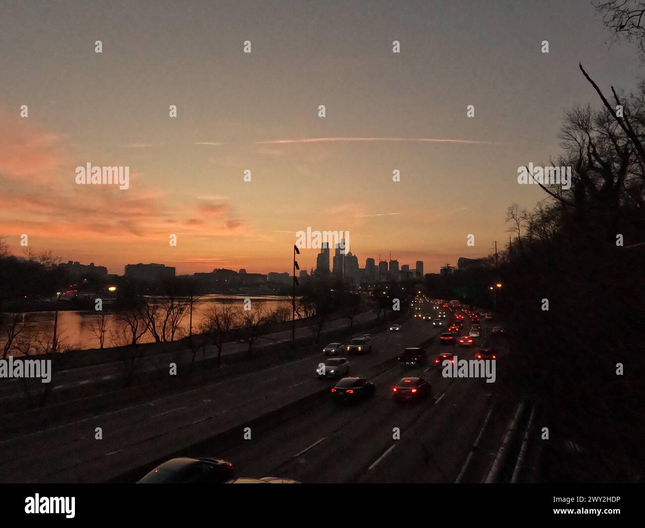 The sun rises over the Philadelphia skyline and traffic on the ...