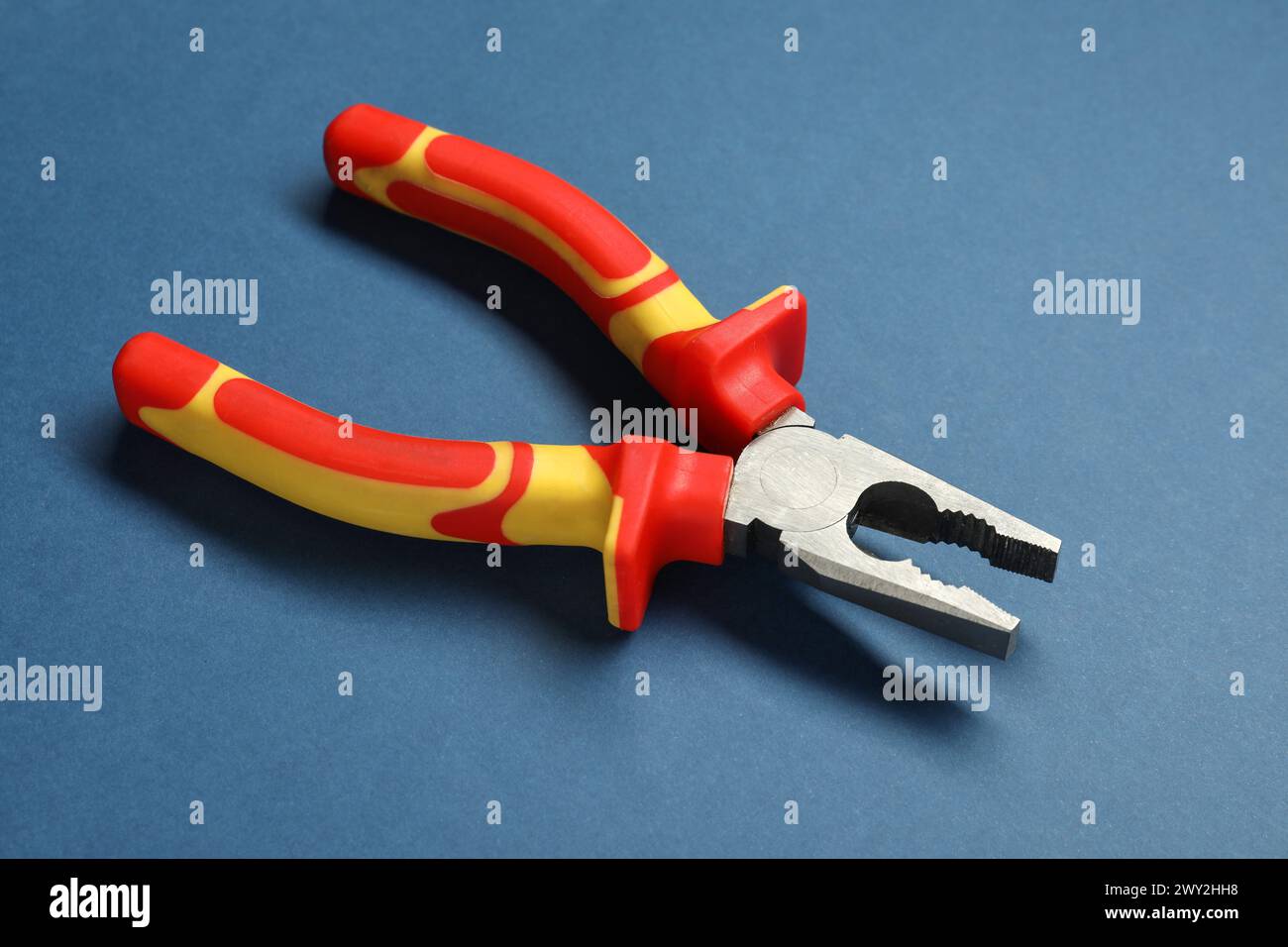 One color combination pliers on blue background Stock Photo - Alamy