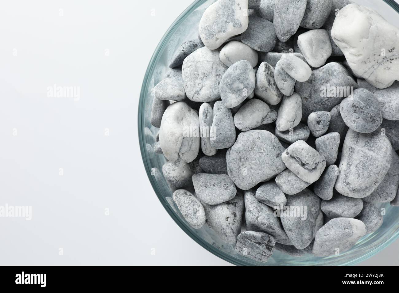 Presentation for product. Glass container with stones on light grey ...