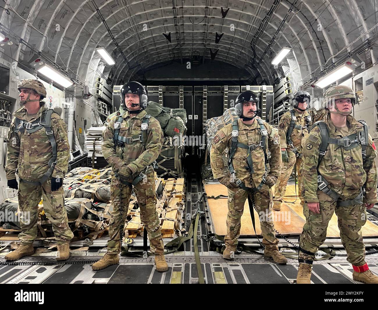 U.S. Air Force Airmen and Army Soldiers stand together inside a C-17 ...
