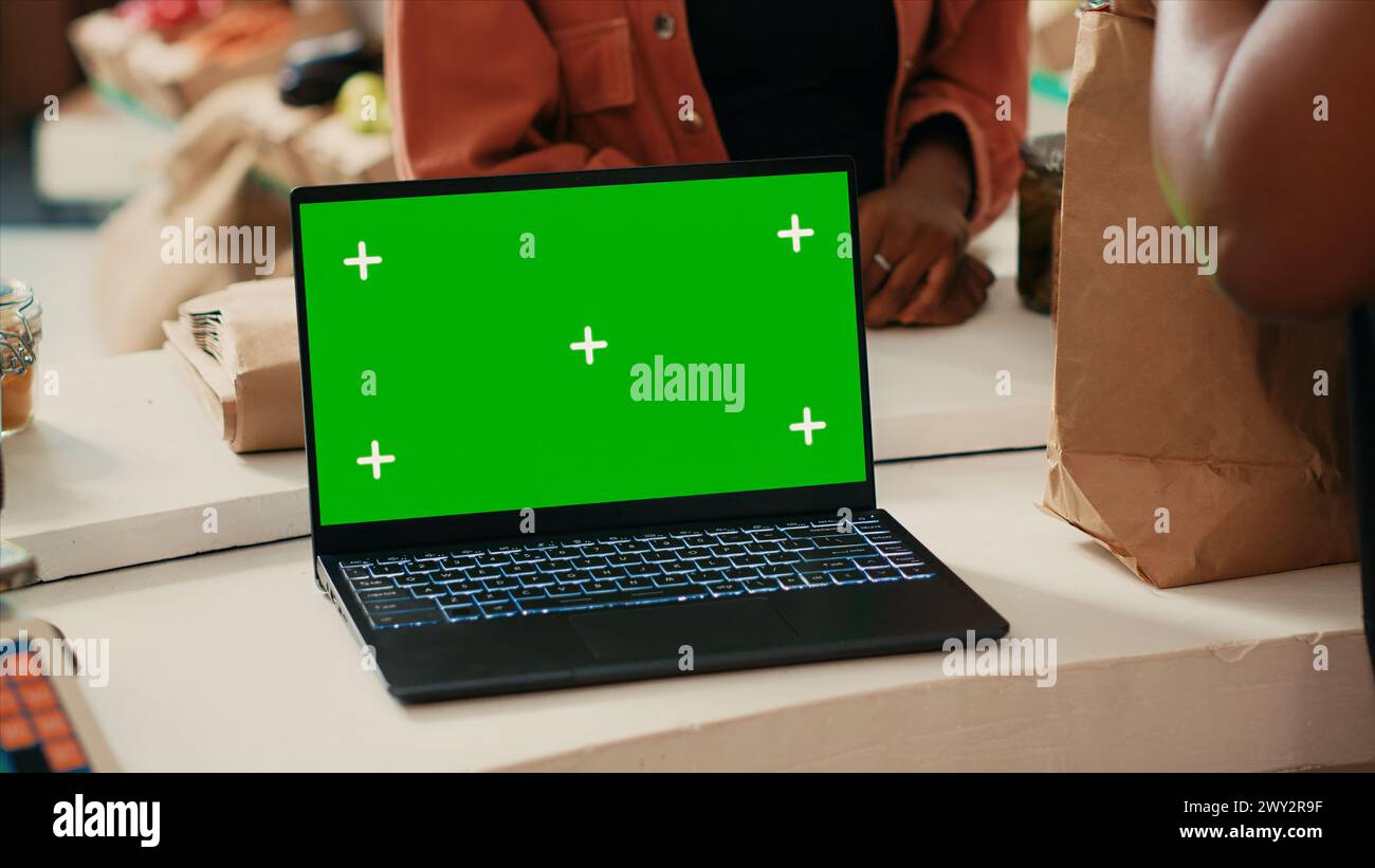 Greenscreen isolated display on laptop at farmers market, local vendor ...