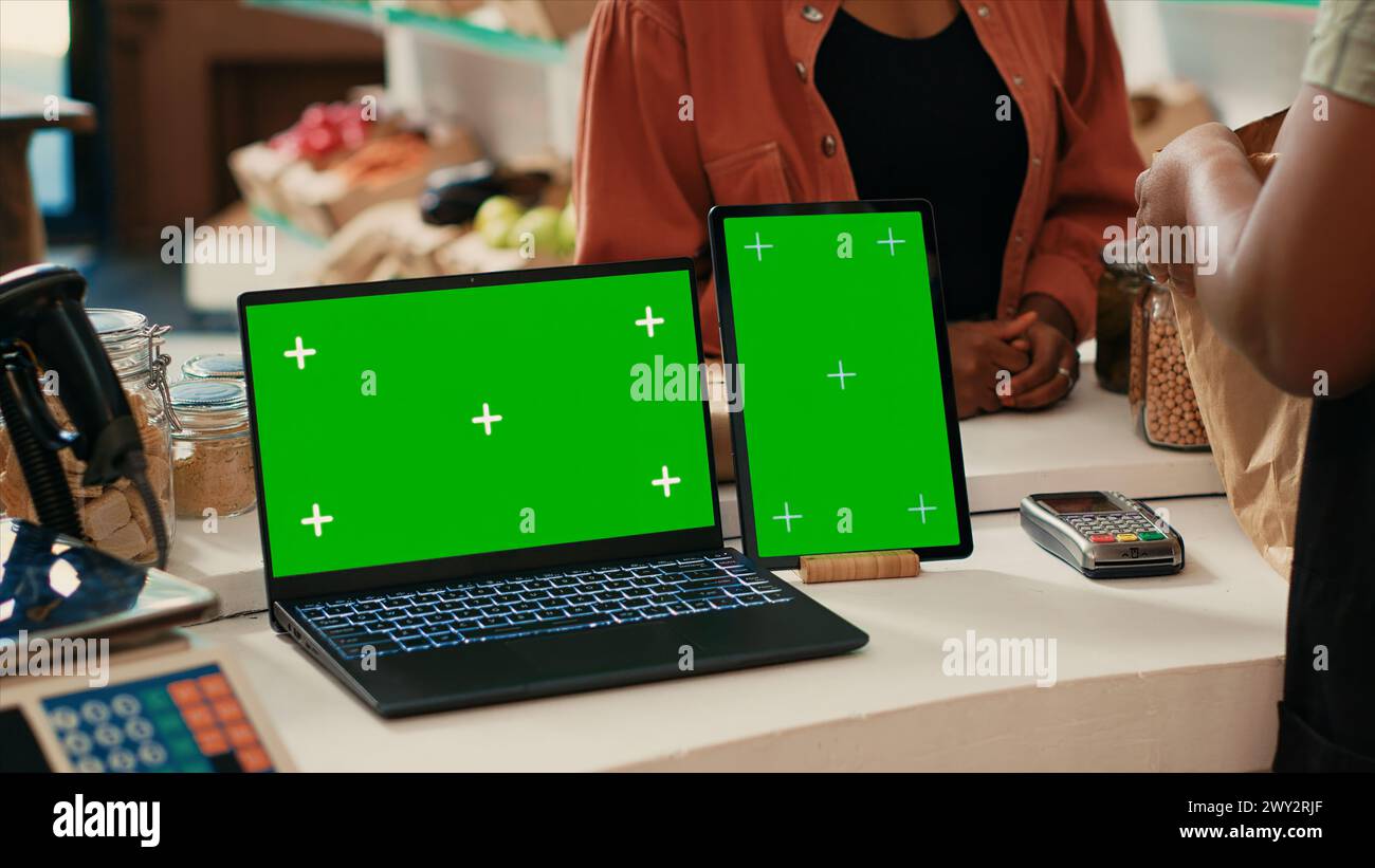 Laptop and tablet running greenscreen layout in local store, promoting ...