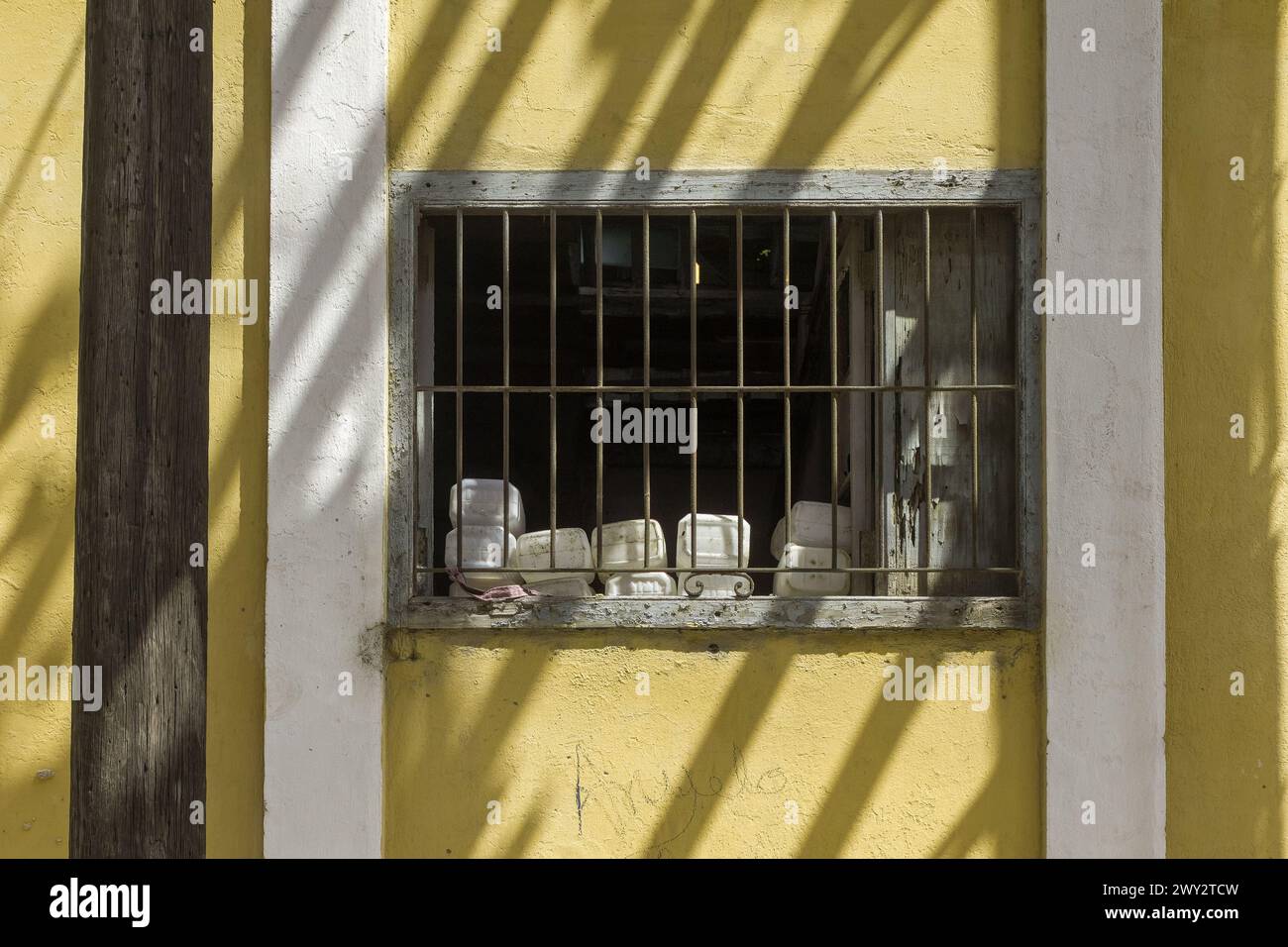 Diverse objects on a window protected by a metal grate, Havana, Cuba ...