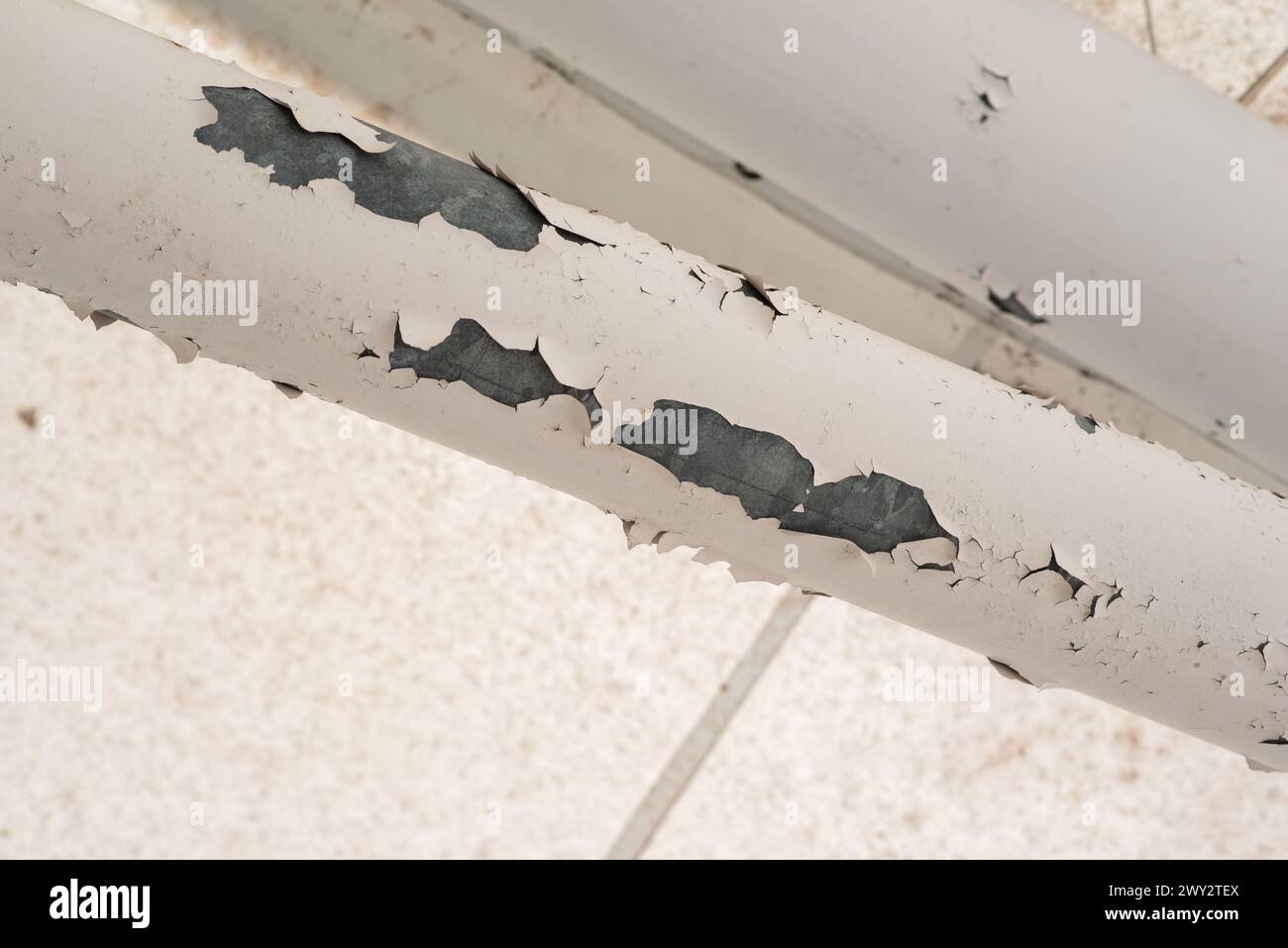 Photography of chiping lead paint on a pipe Stock Photo - Alamy