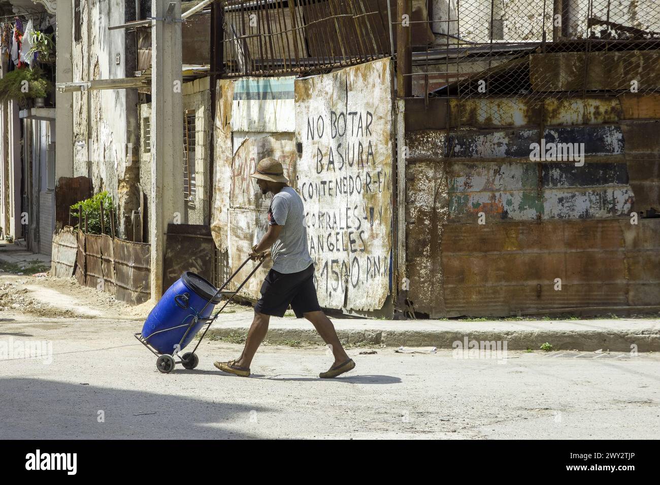 Man pushing cart and plastic tank on city street, Havana, Cuba Stock ...