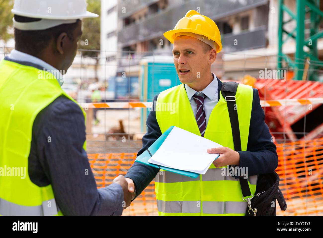 Two successful civil engineers exchange a friendly handshake Stock ...